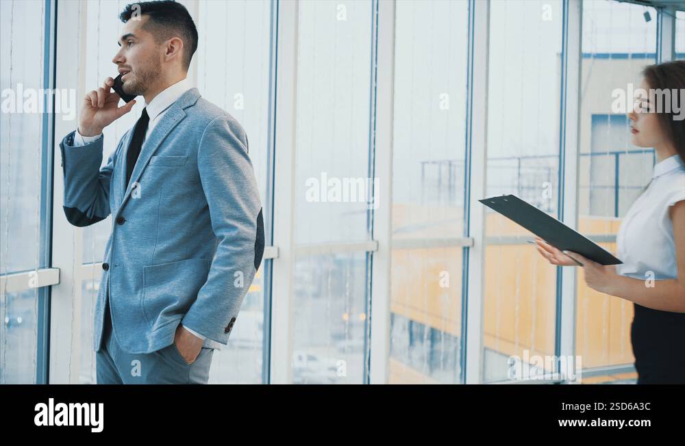 Successful team. Copy space. Boss is busy on the phone. He singifies ...