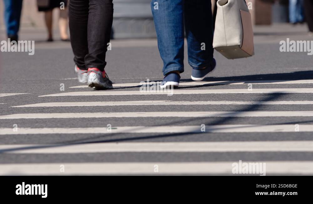 Legs of people walking on a crosswalk of a street - St. Petersburg ...