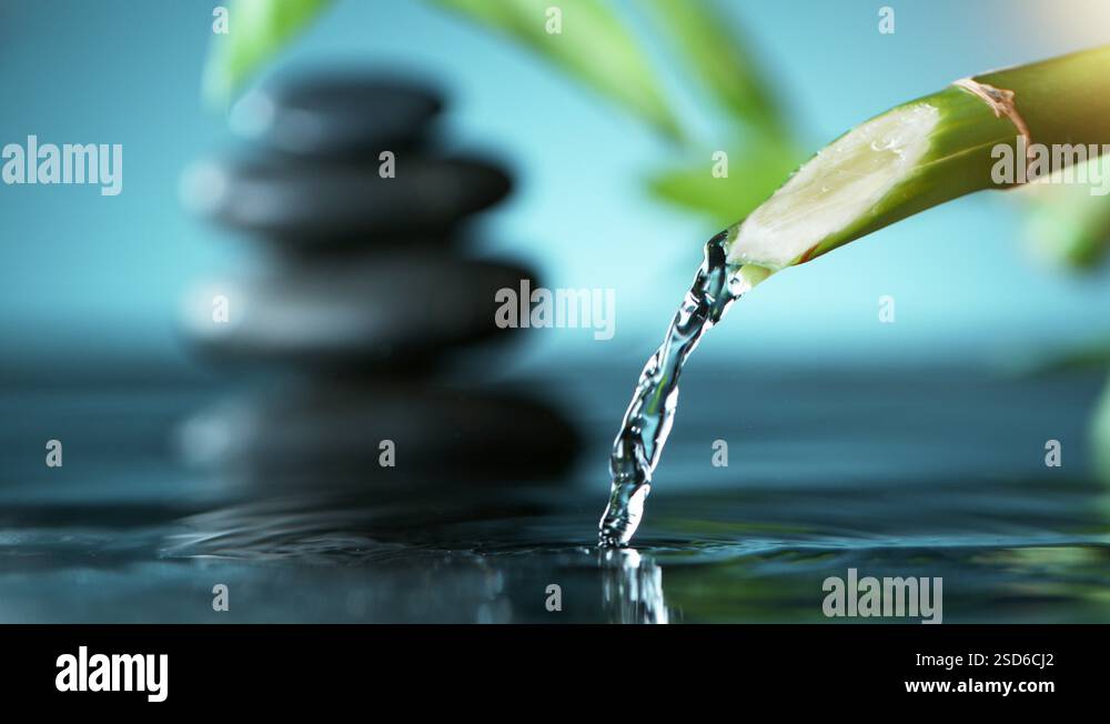 Super slow motion of leaking water stream from bamboo, spa and wellness ...