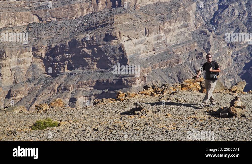 Young Foreign Male Tourist Hiking along Balcony Walk Trail at Wadi Ghul ...