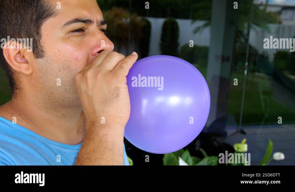 Man blowing up balloon, then it runs away from his hands and deflate ...
