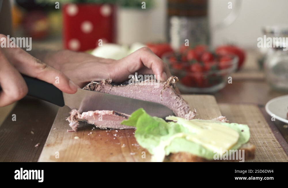 Hand cutting ham and preparing sandwich, slow motion shot at 240fps HD ...