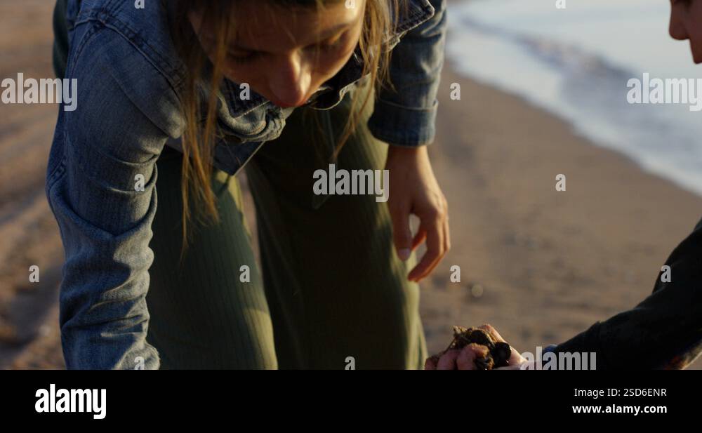 Toddler boy and mother picking up sea shells on ocean beach - summer ...