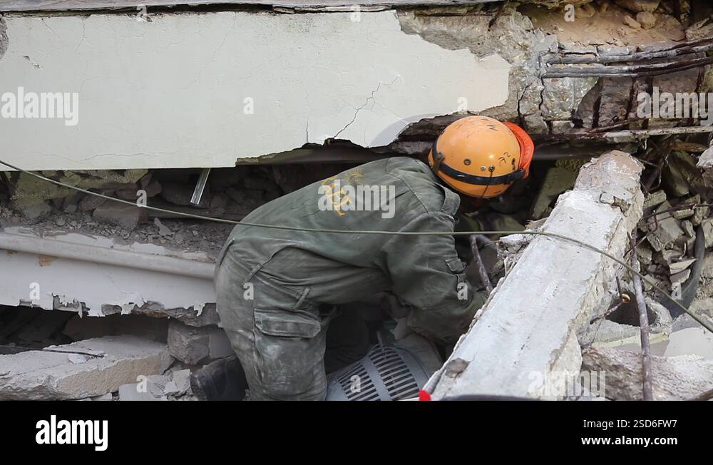 Female soldier search for earthquake casualties digging through the ...