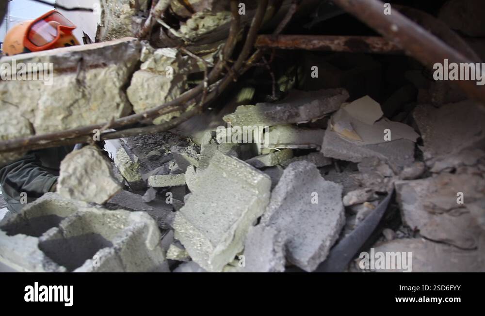 Soldiers search for earthquake casualties digging through the rubble ...