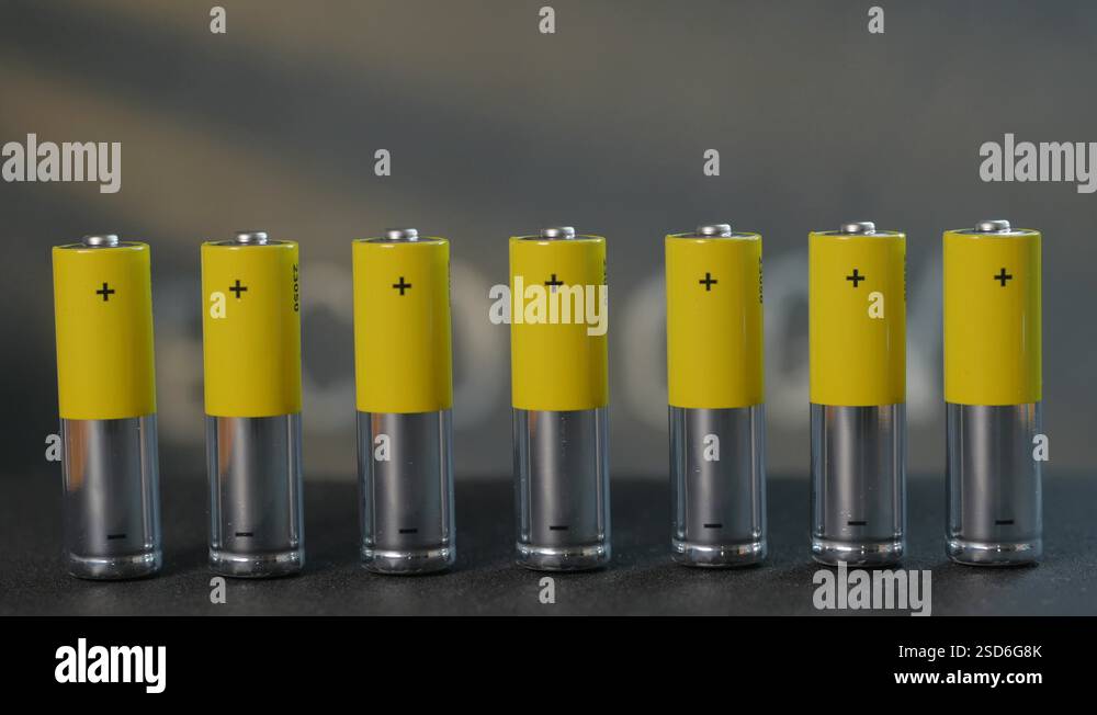 The concept of ecology, the finger of a man pushing seven AA batteries ...