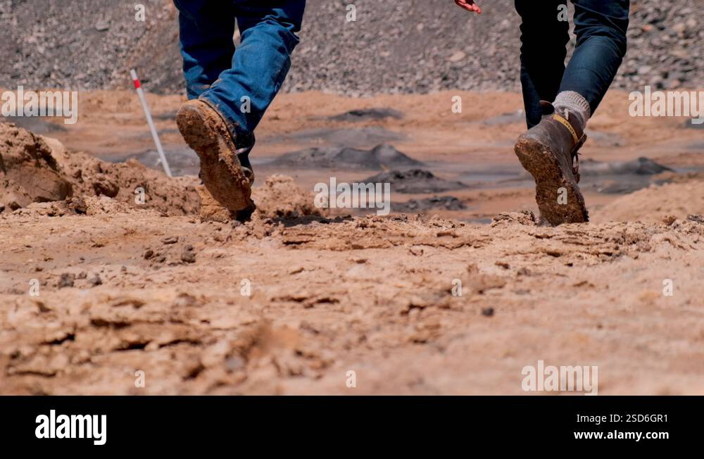 Safety Officers inspecting mine and walking in muddy path Stock Video ...