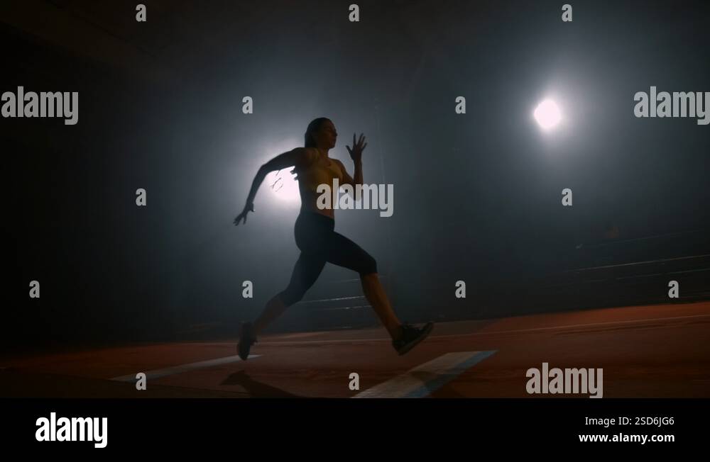 Women's track and field in slow motion, performing a long jump with a ...