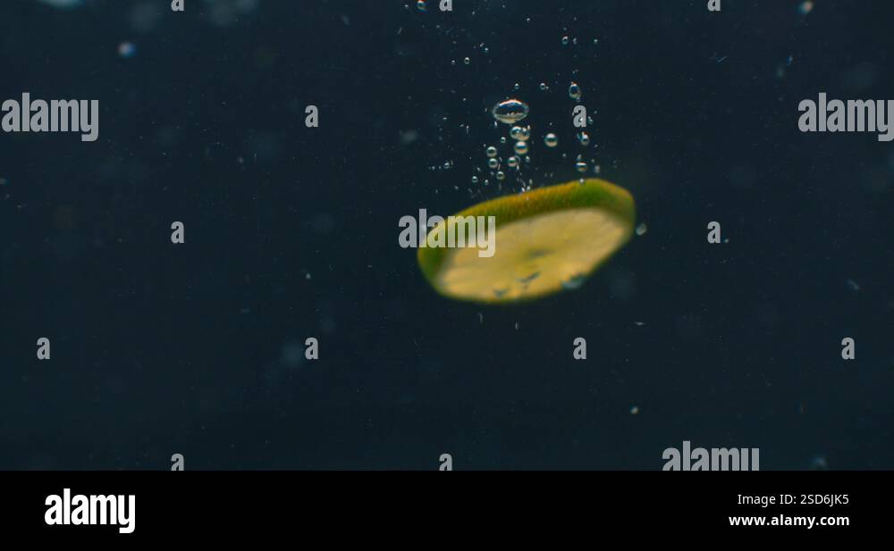Lime rings Underwater with air bubbles and in slow motion. Fresh and ...