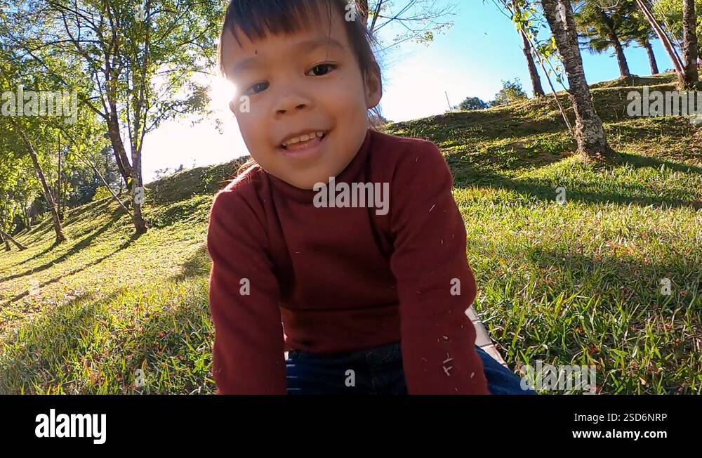 Child girl having fun to play slide with recycled cardboard box on ...