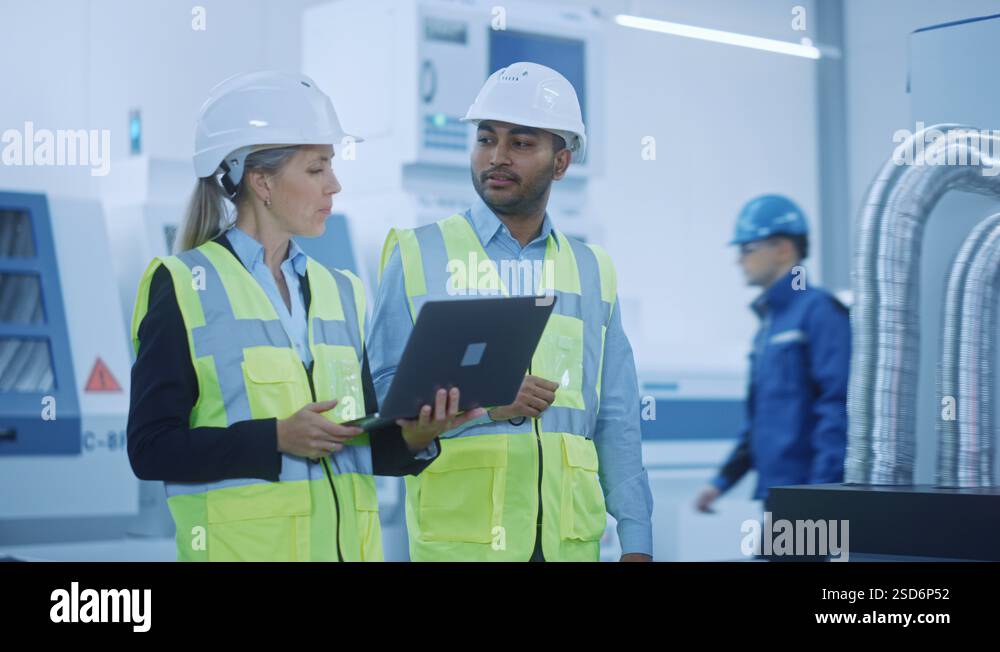 Chief Engineer and Project Manager Wearing Safety Vests and Hard Hats ...