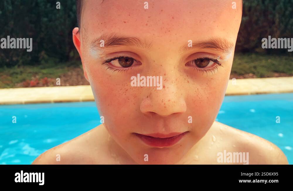 Young boy looking at the camera and falling into a swimming pool Stock ...