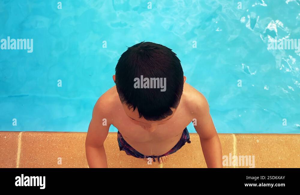 Young boy pretending to be pushed into a swimming pool Stock Video ...