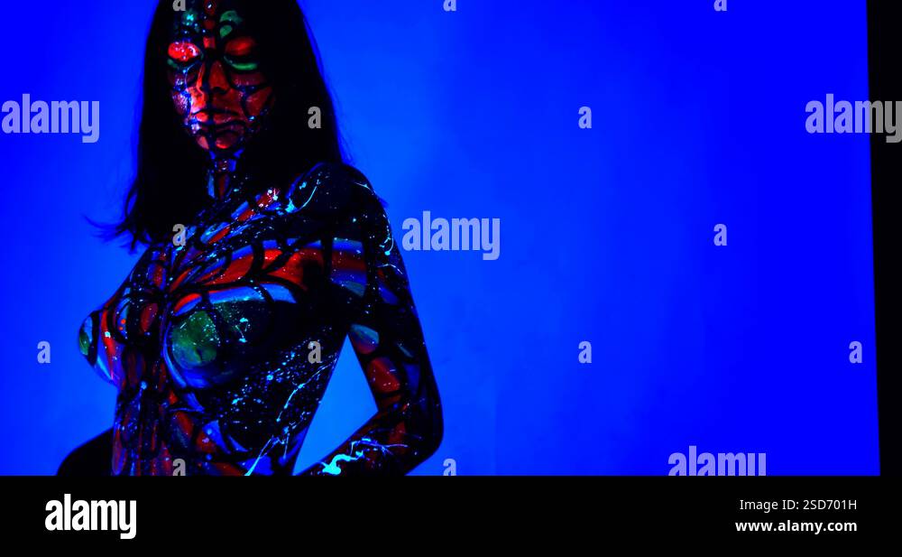 Glowing colorful body art on a young woman dancing and posing in uv ...