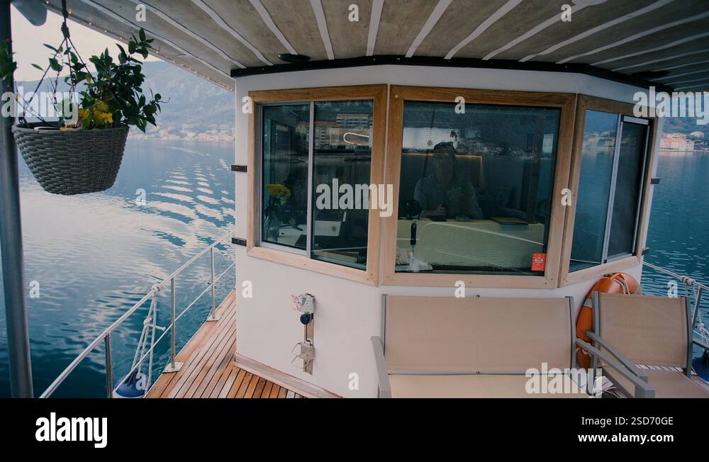 Man controls a steering wheel in a floating house on the sea in ...