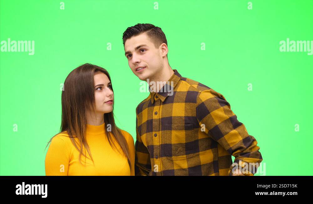 Young happy couple is showing something together. Close up. Copy space ...