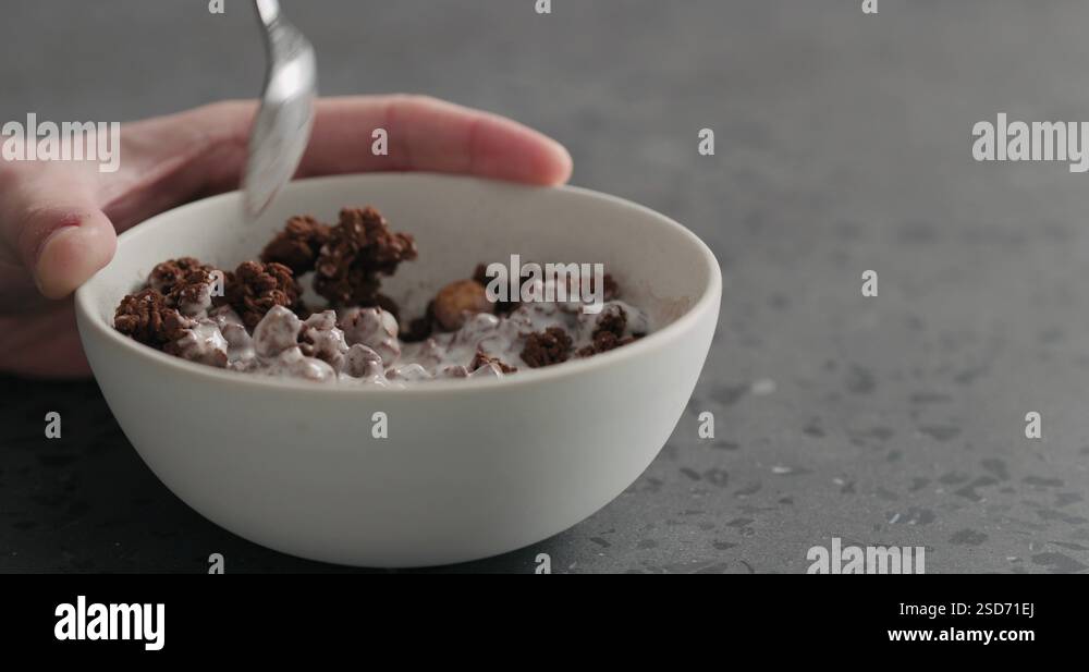 Slow motion man hand mixing chocolate granola with yogurt Stock Video ...