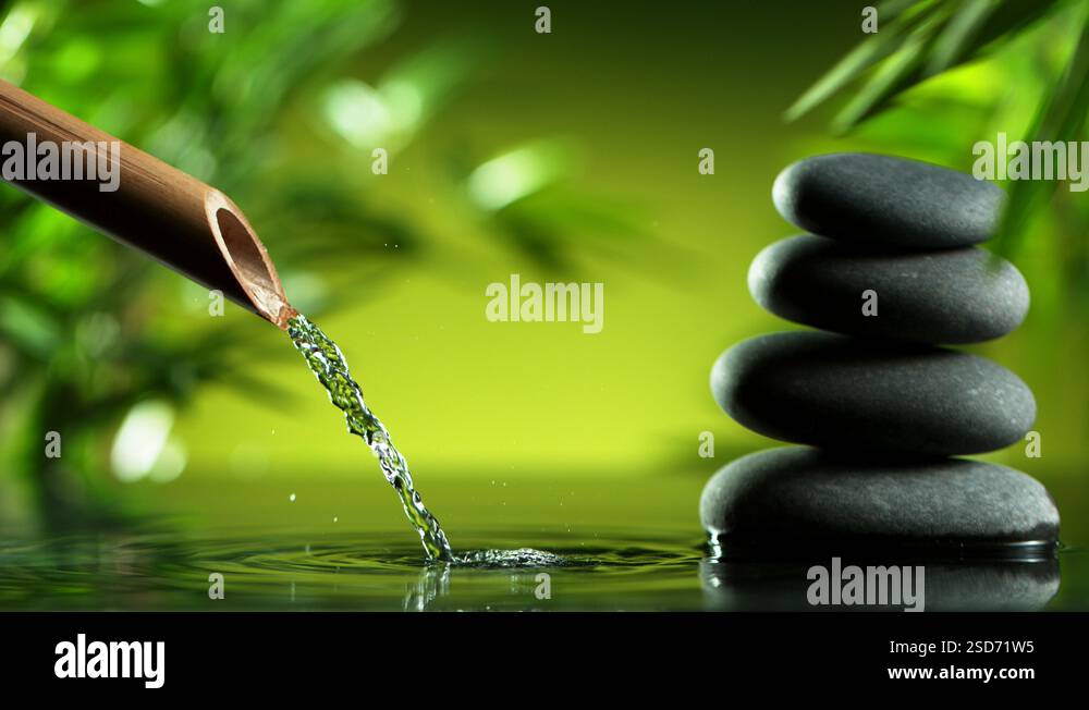 Super slow motion of leaking water stream from bamboo, spa and wellness ...