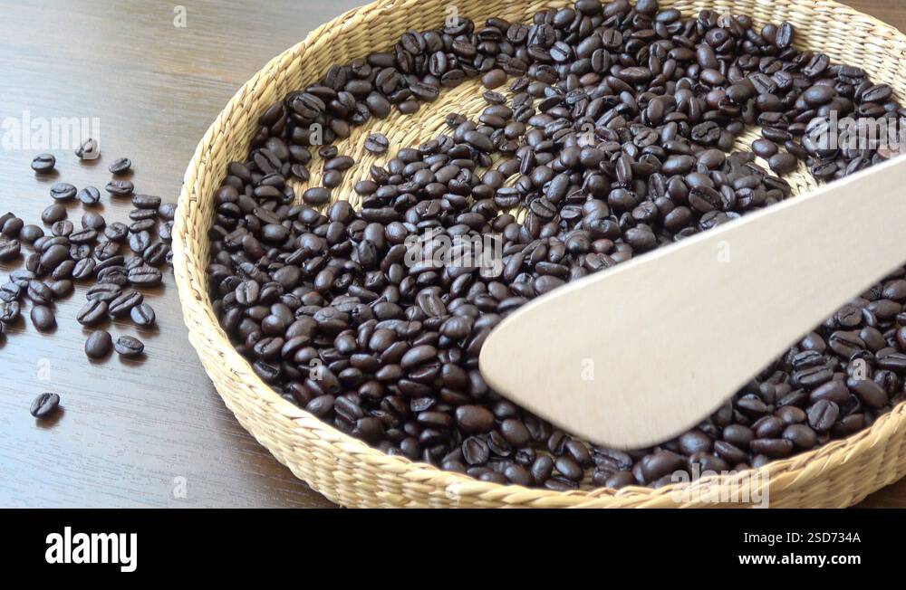 Roasted coffee beans closeup. Fragrant coffee beans. Scoop stir coffee ...