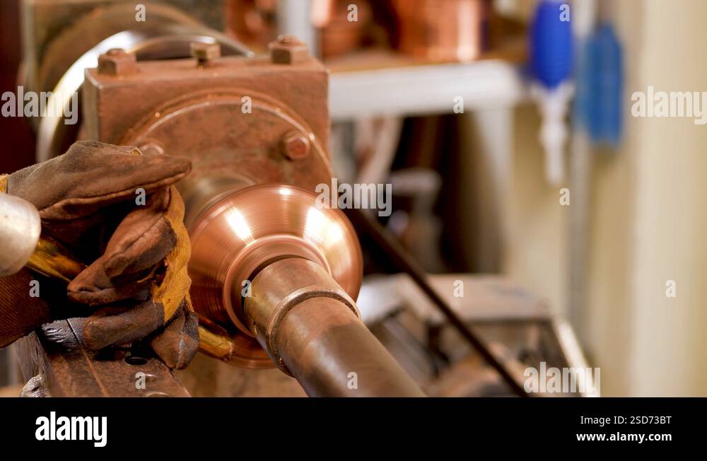 The master grinds a part of a copper product using a lathe Stock Video ...