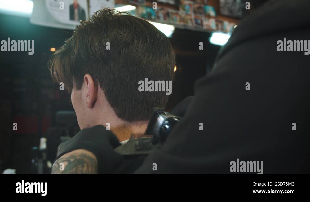 Barber makes finishing touches with a hair trimmer on dry hair after the haircut Stock Video ...
