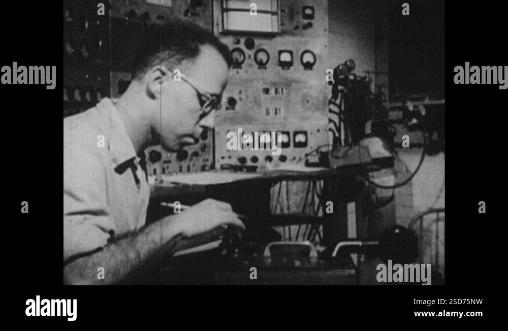 1950s: Scientist checks Geiger counter and writes on clipboard. Man ...