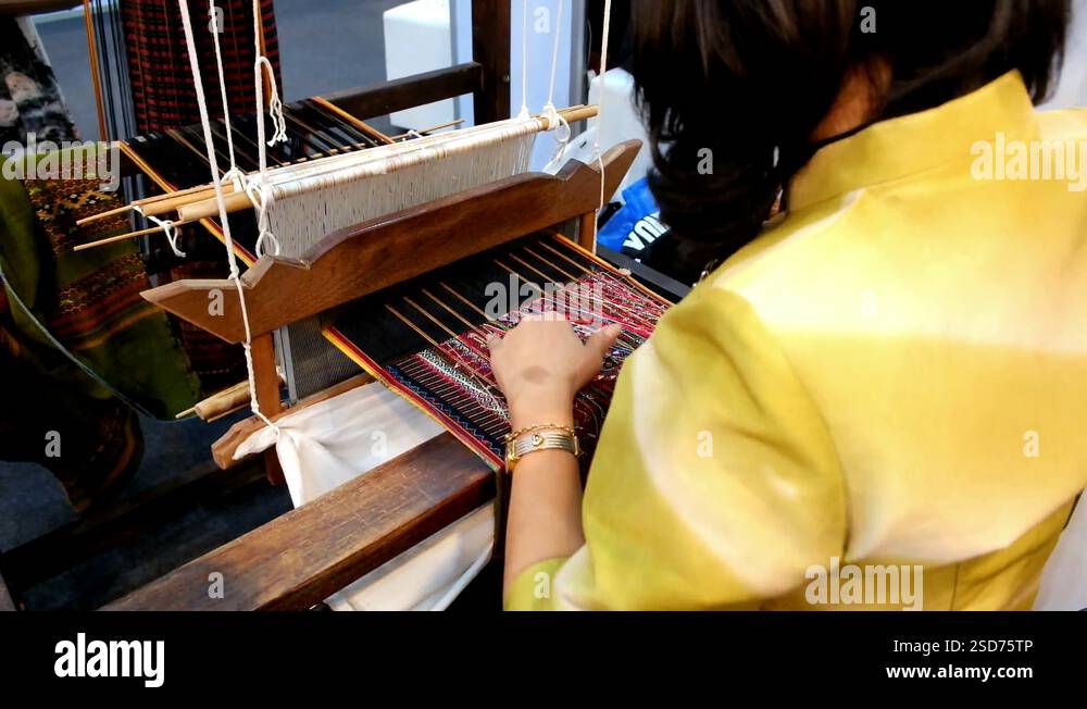 Thai professional weaver demonstrating silk fabric weaving with loom ...