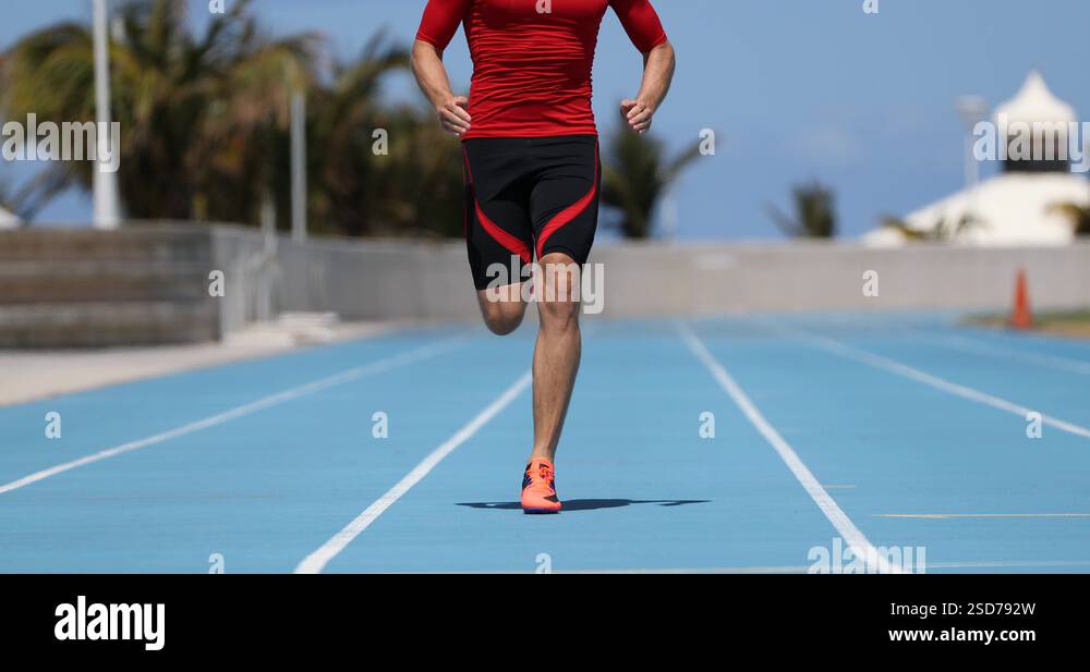 Sprinter runner athlete man sprinting training on athletics track and ...