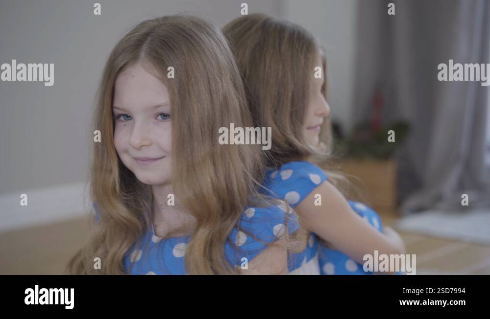 Camera moving from left to right around two identical twin sisters in ... Camera moving from left to right around two identical twin sisters in ...