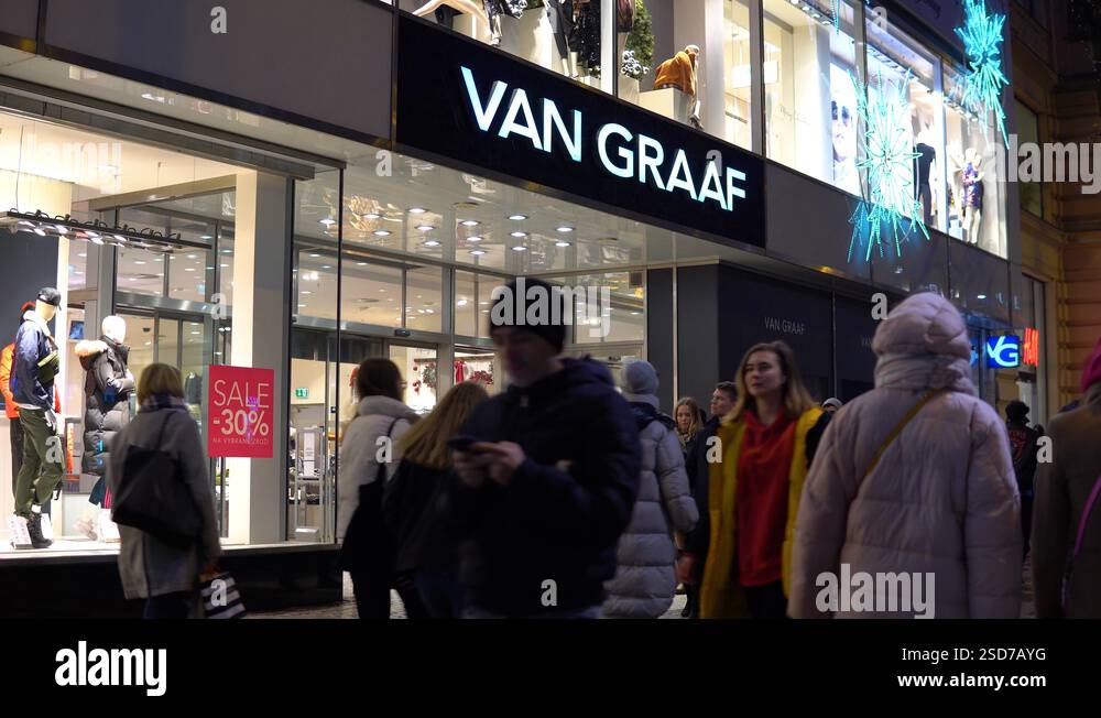 People walk on a street in front a Van Graaf clothing store Stock Video ...