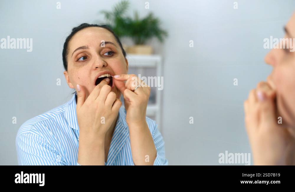 Dental floss, brushing your teeth in the bathroom.Girl brushing her ...