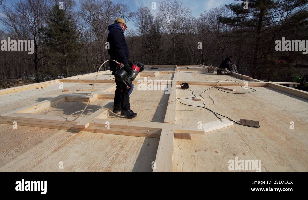 Timelapse: builders attach planks on the second floor of frame house ...