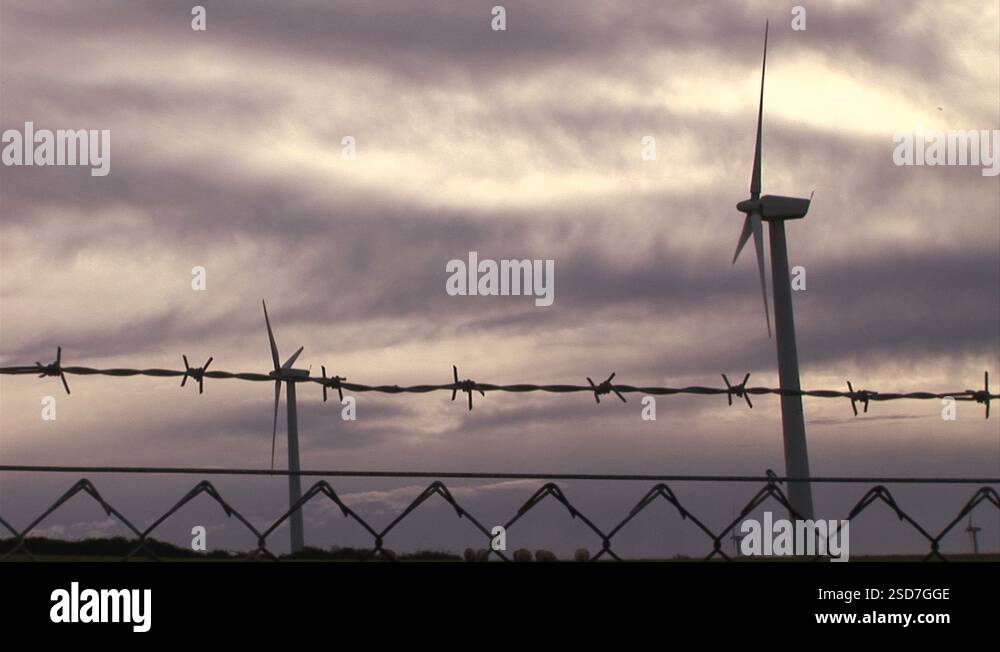 Wind turbine with barbed wire in foreground Stock Video Footage - Alamy