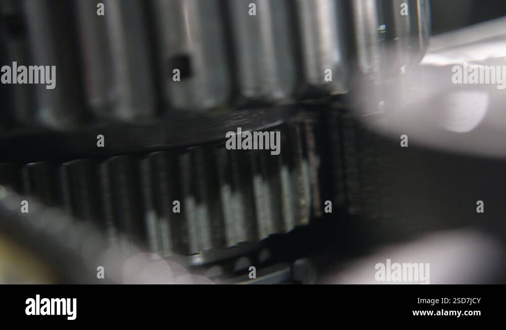 Large cogwheel rotating quickly using metallic chain in modern auto ...