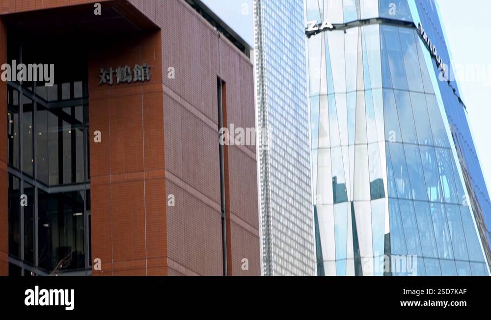 Slow motion of a maintenance worker cleaning windows on high rise ...
