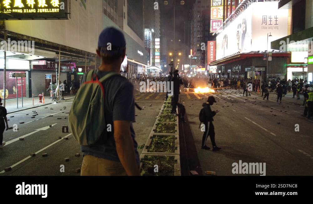 People protest and barricade the road at night during Hong Kong ...