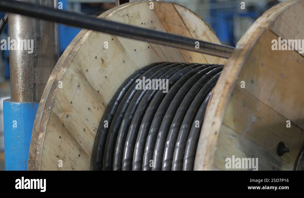 Winding cable on a rotating coil. Production of electric cable Stock ...