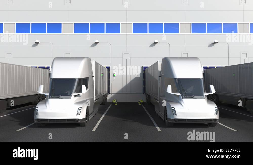 Electric semi-trailer trucks at warehouse loading bay with EXXON MOBIL ...