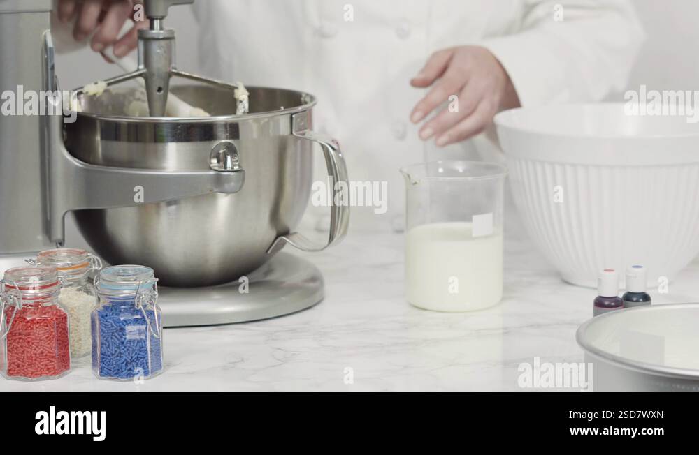 Mixing ingredients in standing kitchen mixer to bake a three-layer ...