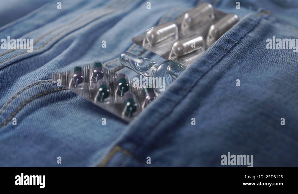 Ampoule for injection and two blister packs with green gray capsules in ...