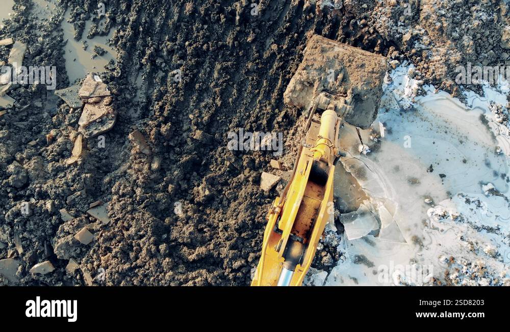 Building, construction process. Excavator's bucket is grabbing soil and ...