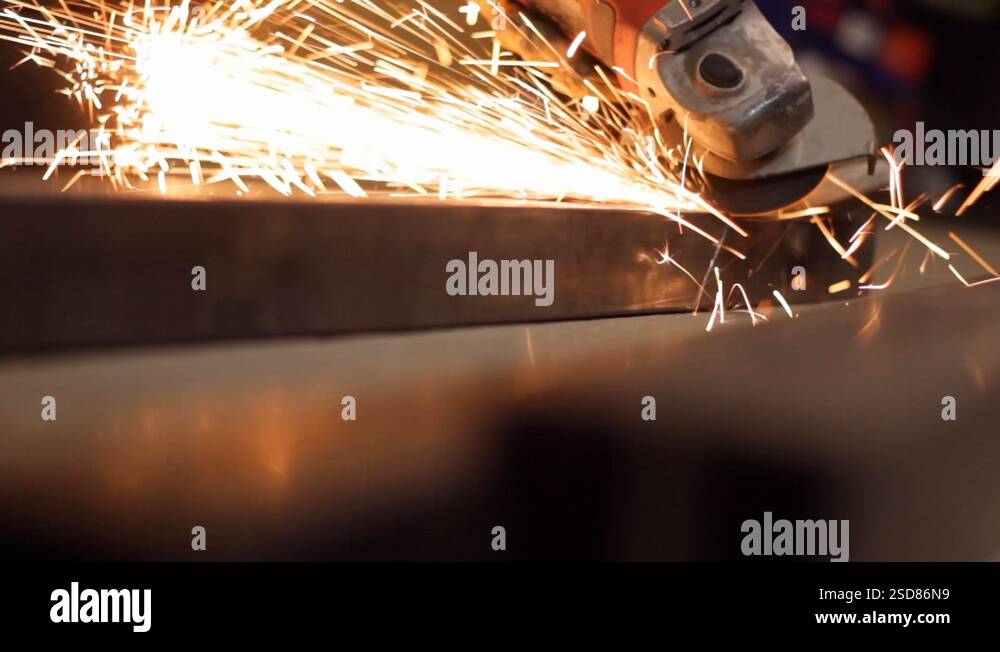 Angle grinder making a side cut with fire sparks flaring, closeup Stock ...