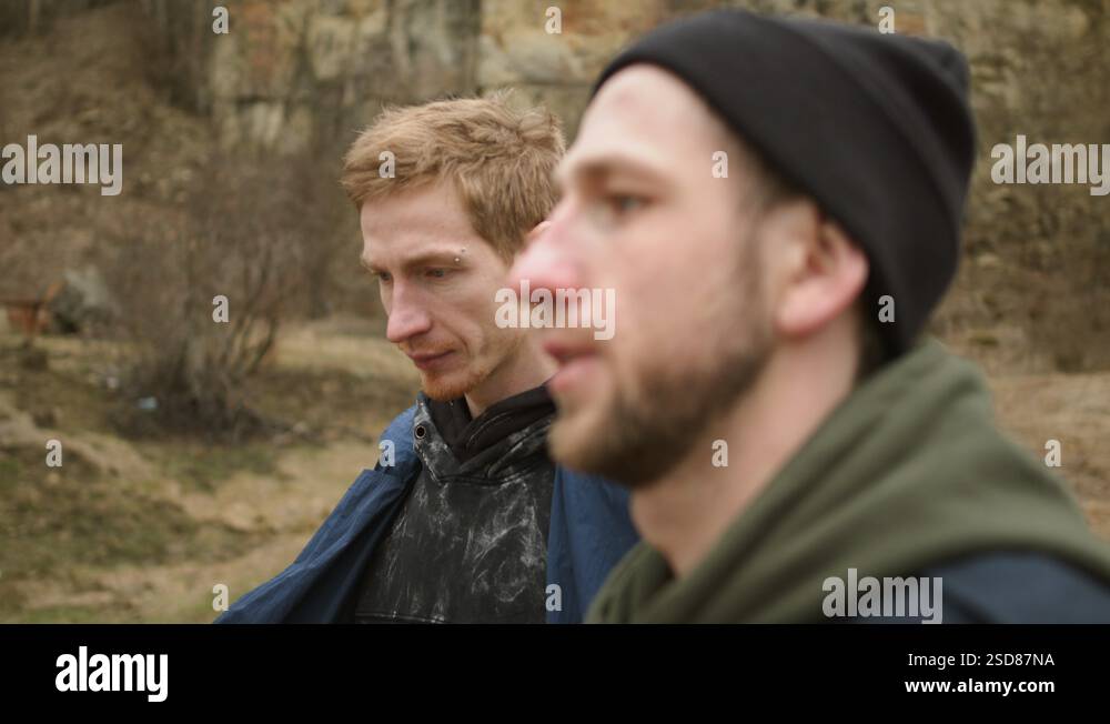 Two Young Guys Walking On The Road In Nature. They Joke And Laugh Stock ...