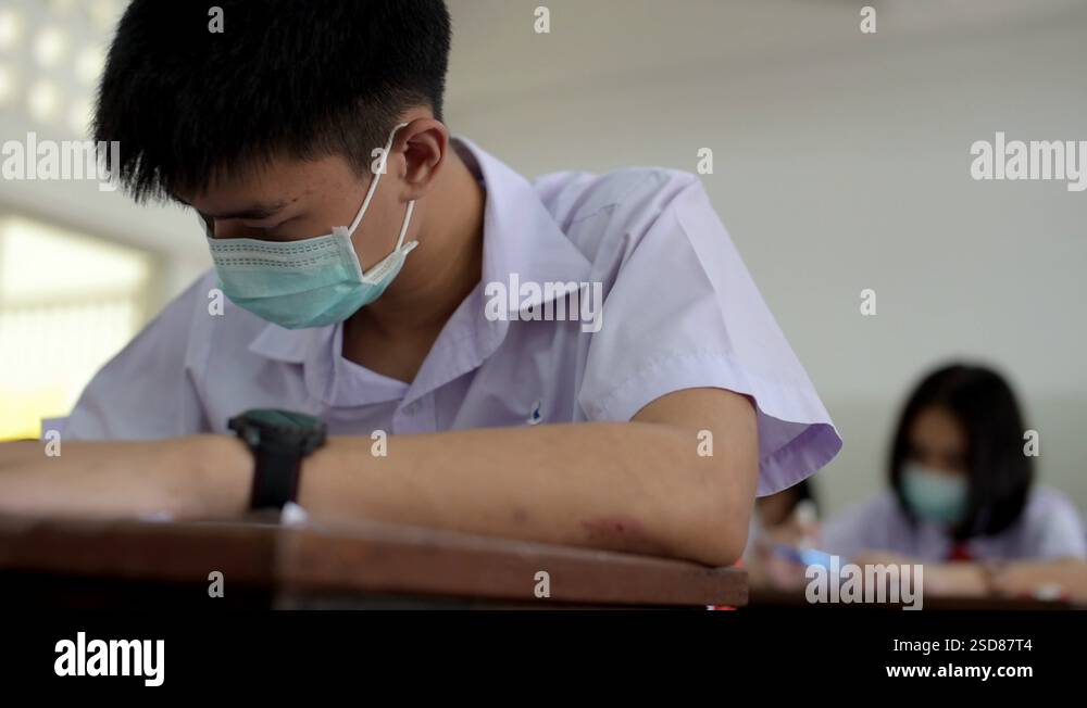 Asian high school students in a white school uniform wearing the masks ...