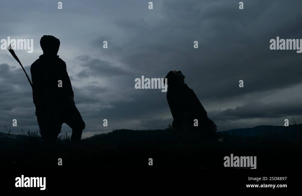 Two Young Guys On Cloudy Sky Background At Dusk. One Guy Hits The Other ...