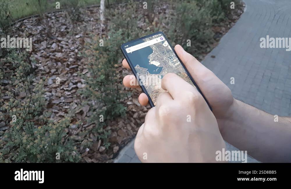 Top view on male hands using smartphone on the street. Man using map ...