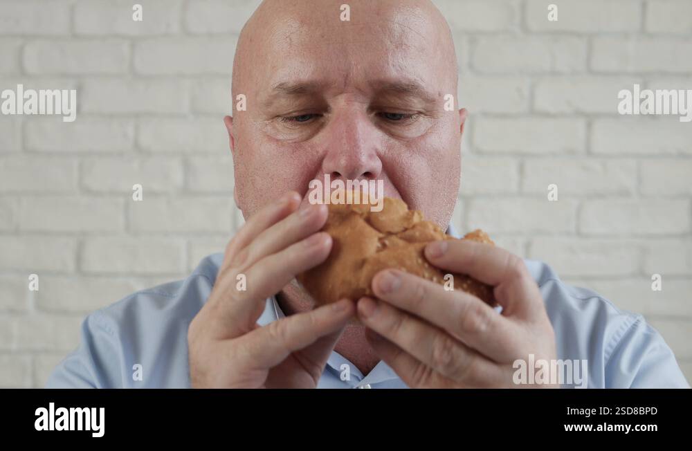 Hungry Person Eating a Tasty Hamburger and Linking His Fingers in a ...