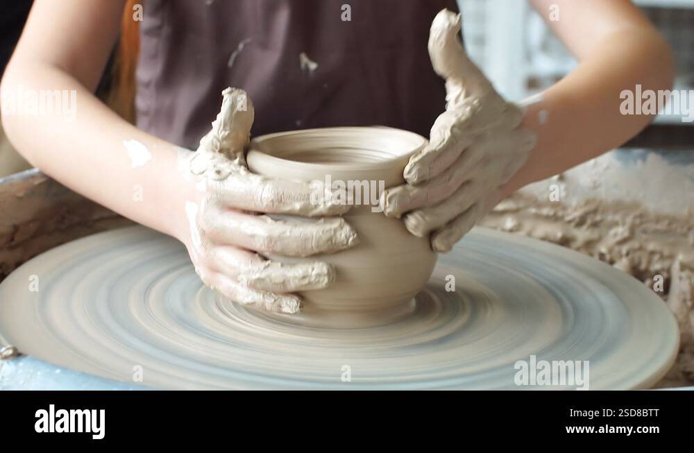 Creating a clay pot. Potter. Workshop of clay. Clay on the device ...