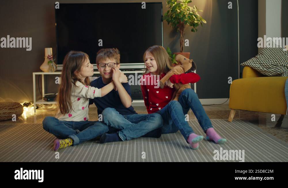 Happy lovely moment of triplets little kids hugging and kissing in cozy ...