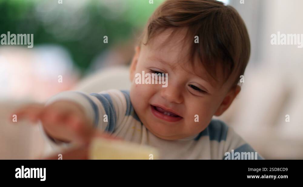 Baby trying lemon for first time, infant toddler face expression ...